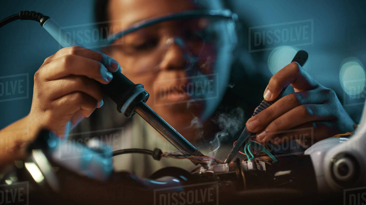 Young Teenage Schoolgirl is Studying Electronics and Soldering Wires ...
