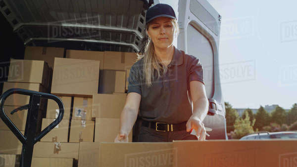 Female Worker Loading Delivery Truck with Cardboard Boxes - Royalty ...