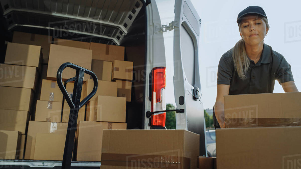 Female Worker Loading Delivery Truck with Cardboard Boxes - Royalty ...