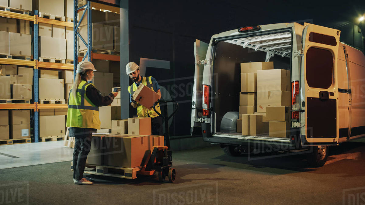 Manager Using Tablet Computer, talking to Worker Loading Delivery Truck ...