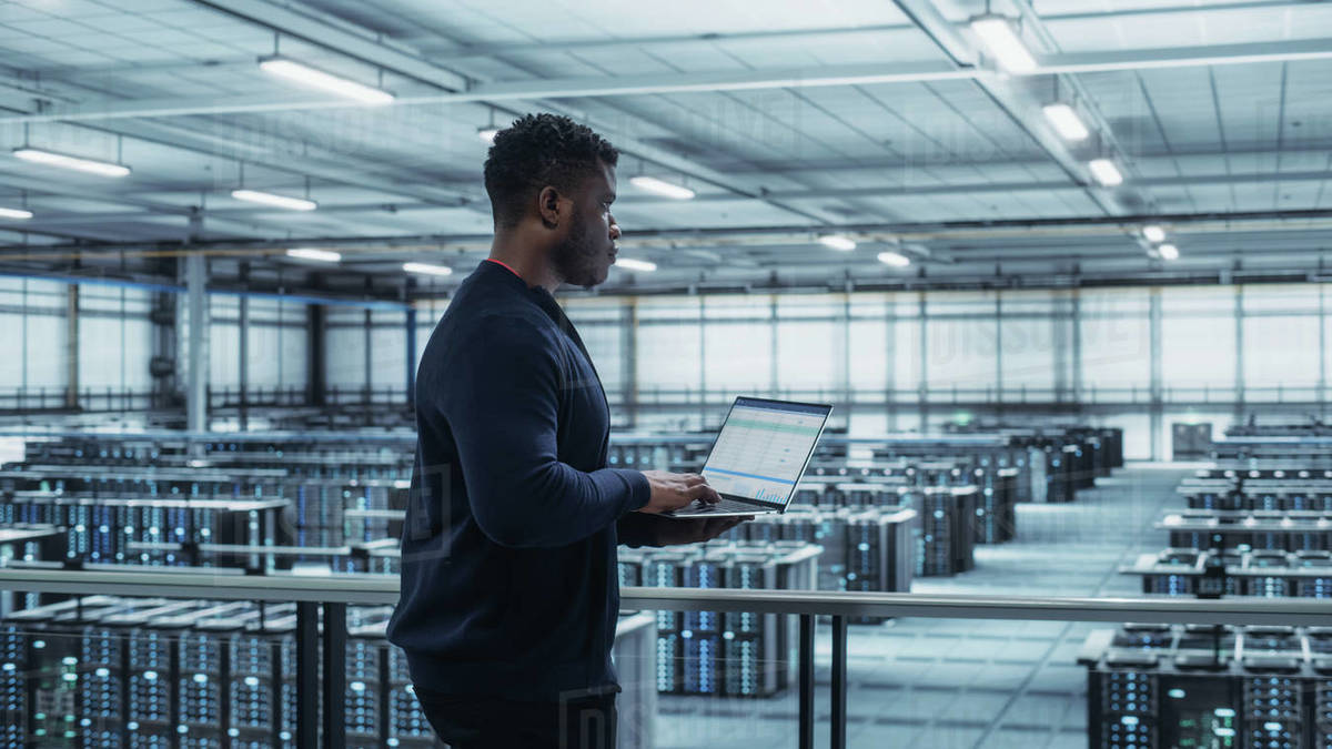 Data Center Engineer Using Laptop Computer - Stock Photo - Dissolve