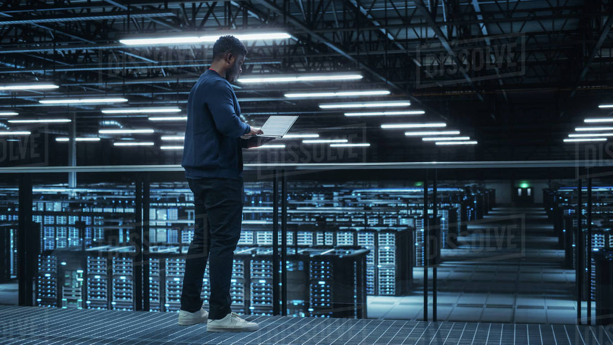 Data Center Engineer Using Laptop Computer - Stock Photo - Dissolve