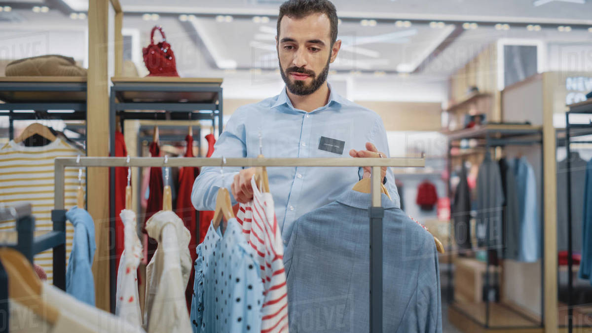 Male Clothing Store Assistant Works in Fashionable Shopping Mall ...
