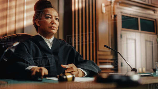 Honorable Female Judge Reading Decision - Stock Photo - Dissolve