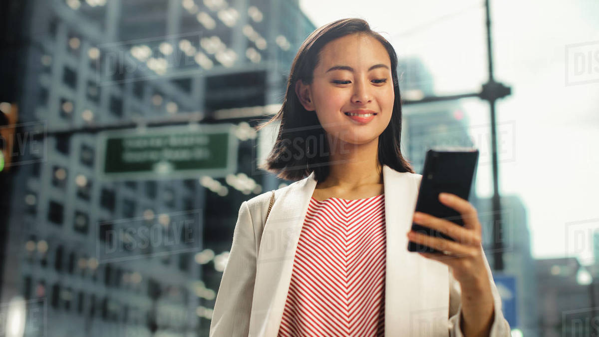 Portrait of a Japanese Female Wearing Smart Casual Clothes and Using ...