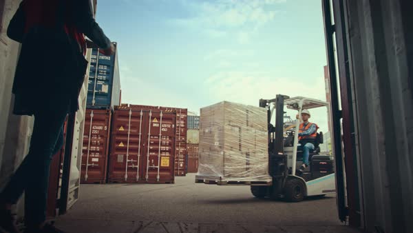 Forklift Driver Loading a Shipping Container with a Pallet with Boxes ...