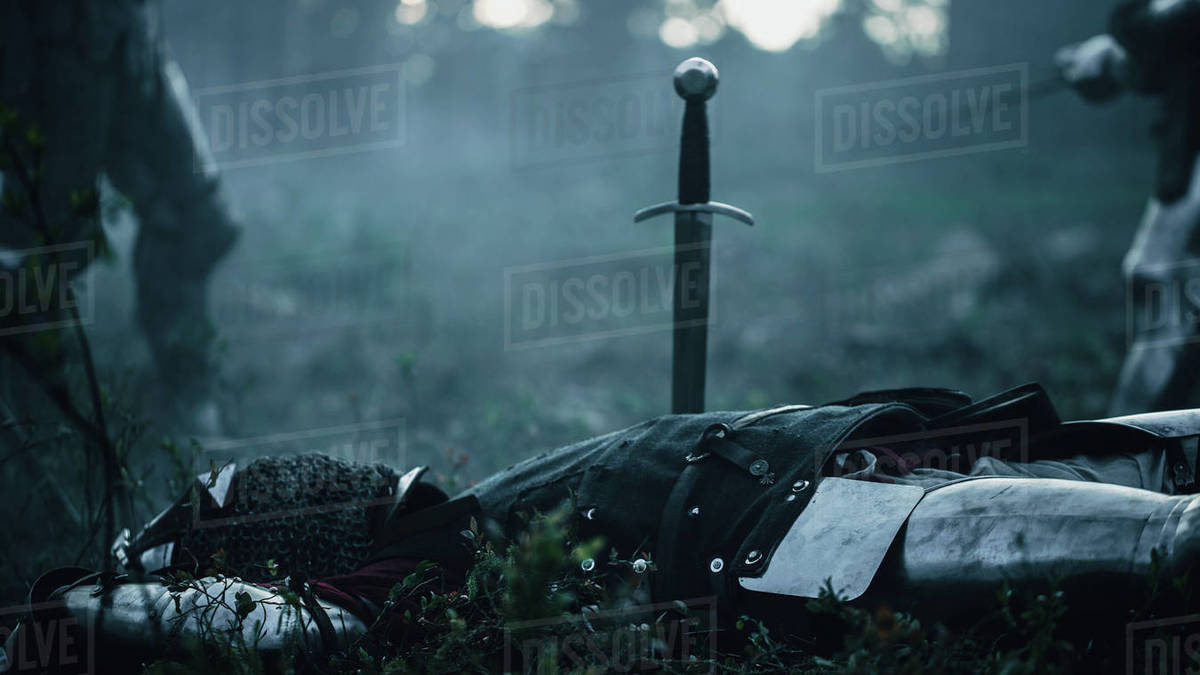 Shot of a Dark Age Battlefield: Dead Body With Stuck Sword. Brutal ...