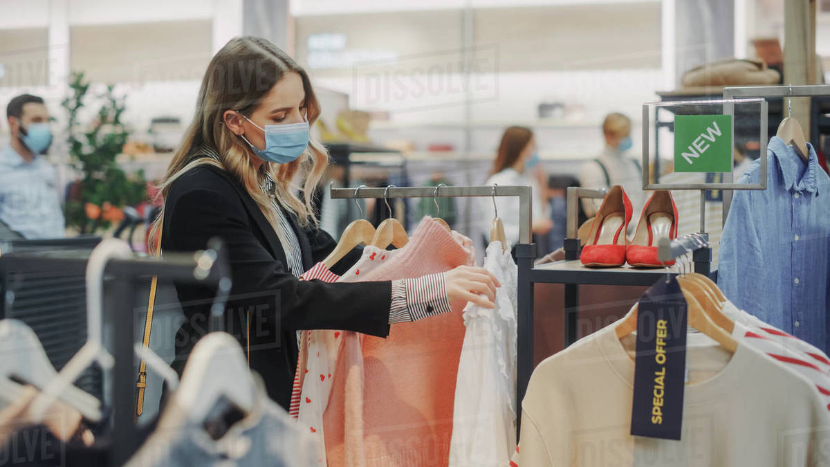 Female Customer Wearing Protective Face Mask Shopping in Clothing Store ...