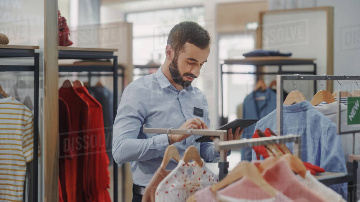 Male Merchandising Professional Uses Tablet Computer To Create ...