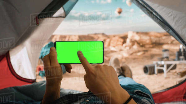 POV View of a Tourist Horizontally Holding a Smartphone with Green ...