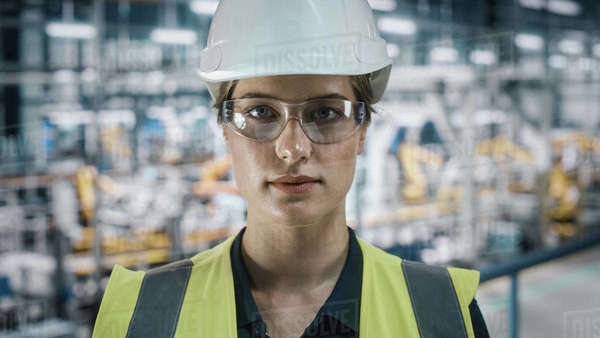 Portrait of Female Automotive Industry Engineer Putting on Safety ...