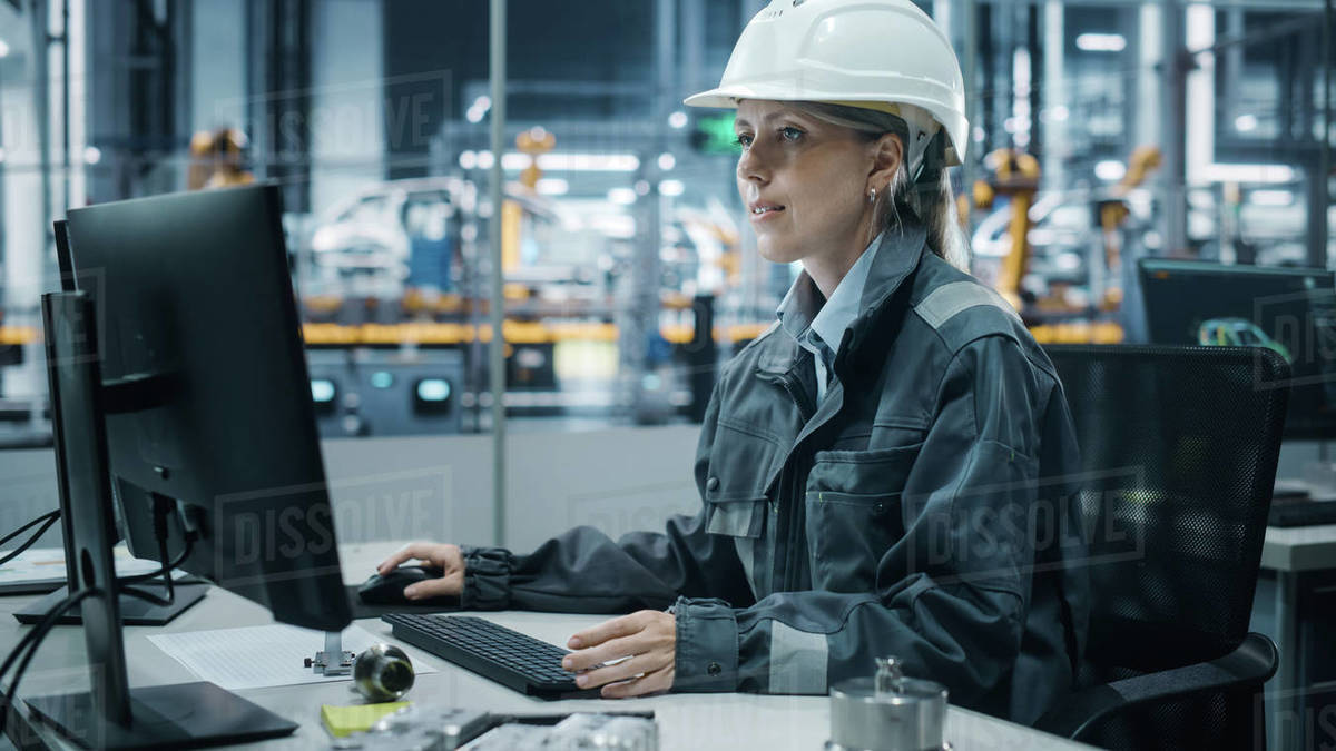 Portrait of Confident Female Chief Engineer Wearing Hard Hat Working on ...