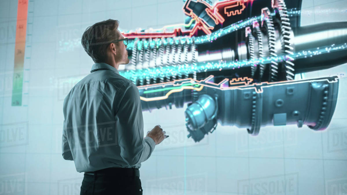 Engineer Designing Engine Using Tablet Computer and Big Wall Screen to ...