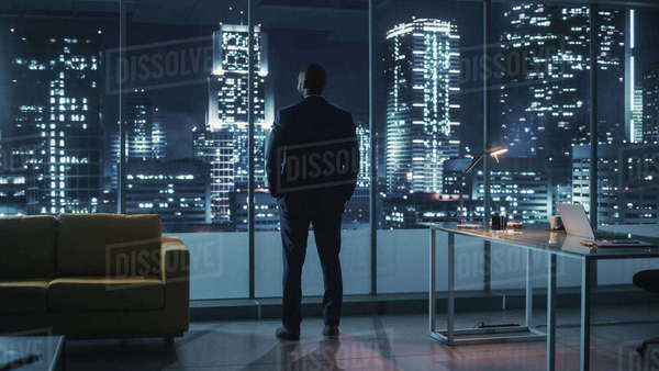 Black Businessman Wearing Suit Standing, Looking out of the Window on a ...