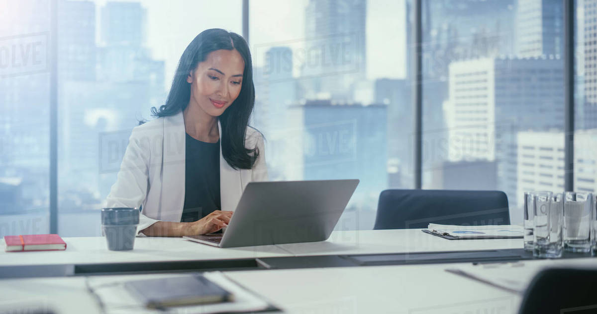 Portrait of Asian Businesswoman Wearing in Stylish Suit Working on Laptop Computer in Big City ...