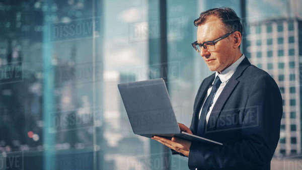 Businessman in a Suit Standing in Modern Office - Royalty-free Stock ...
