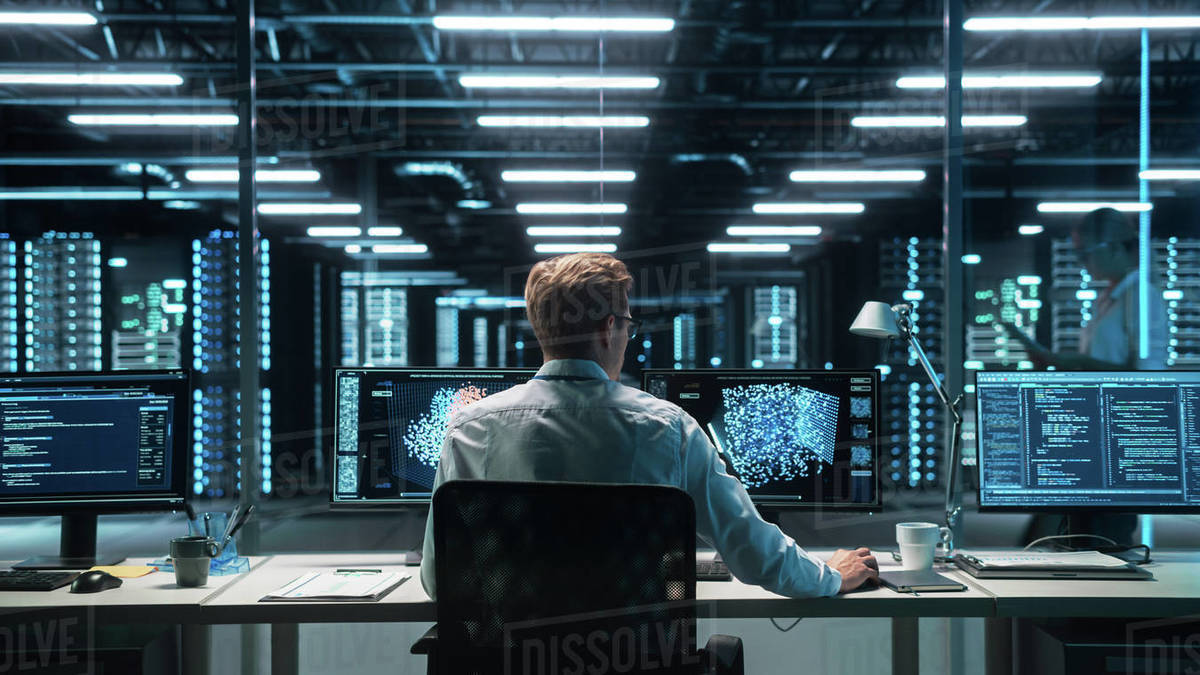 Software Developer Works with AI Analysis on his Computer with Two Monitors. Developer Coding ...