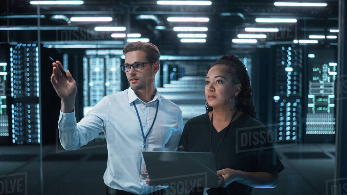 Entrepreneur and IT Specialist Talk and Look at the Laptop in Diverse ...