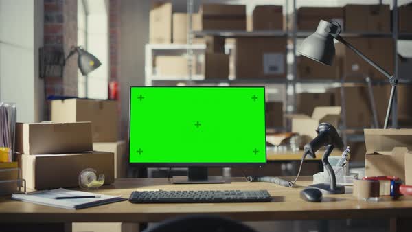 Desktop Computer Monitor Standing on a Table with a Green Screen ...