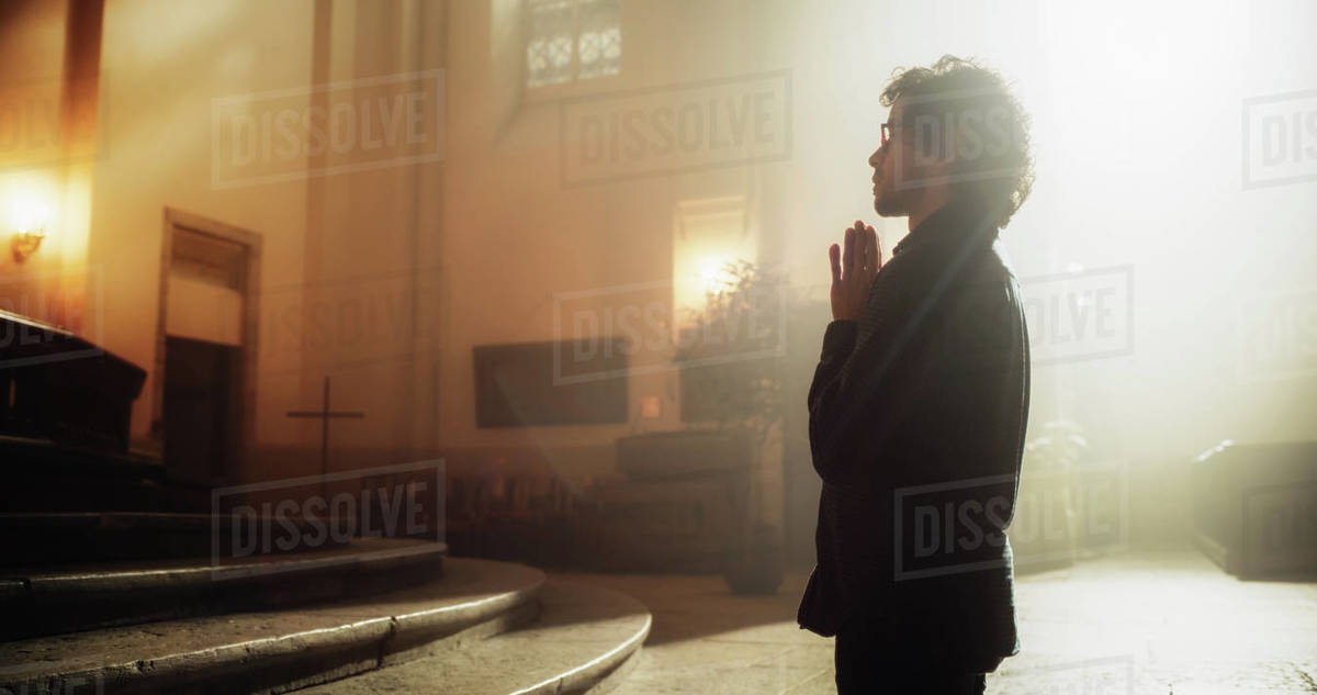Christian Man Getting on his Knees In Front of the Altar and Starting ...