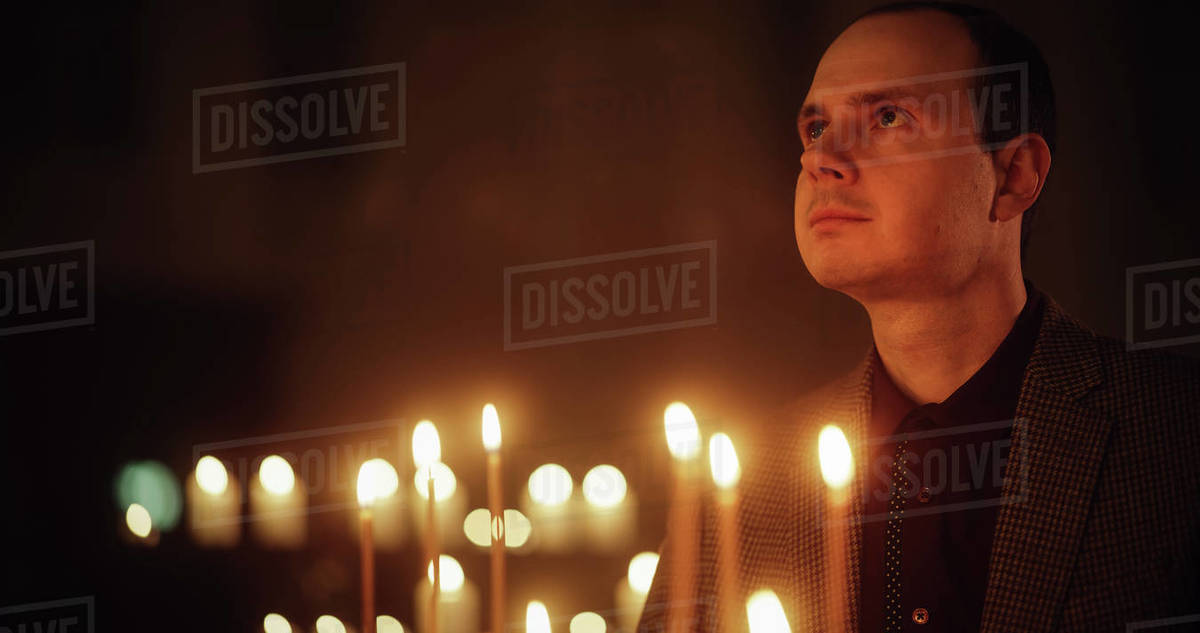 Devout Christian Man Lighting a Candle in Church, Praying and ...