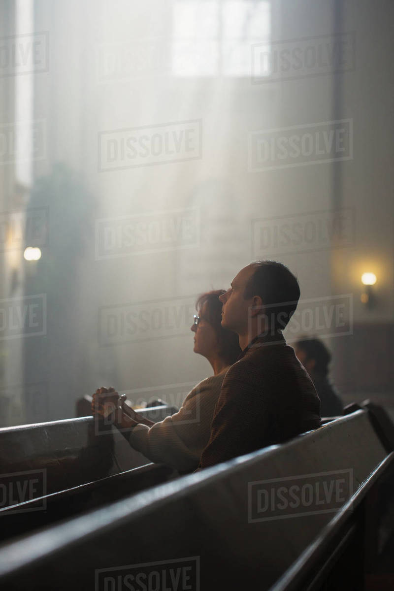 Two People Siting in Church, Praying And Feeling A Connection To God ...