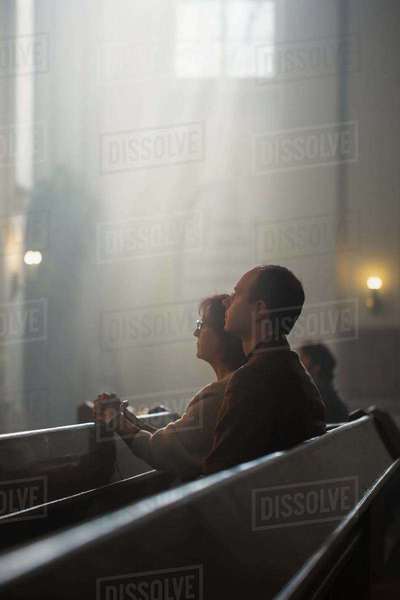 Two People Siting in Church, Praying And Feeling A Connection To God ...