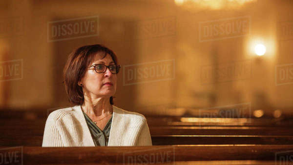 Portrait of a Senior Woman Sitting in a Church Listening Carefully to ...