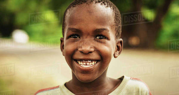 Close Up Portrait of a Shy Authentic African Boy Smiling at the Camera ...