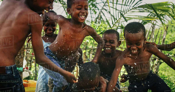 A Group Of African Children, Laughing, Jumping And Playing in Rural ...