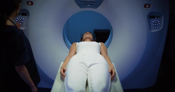 In the Medical Laboratory Female Patient Lying on a CT or MRI Scan Bed ...