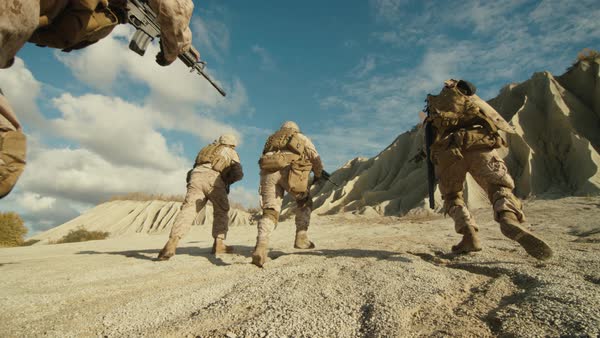 Follow Shot of Squad of Soldiers Running Forward During Military ...