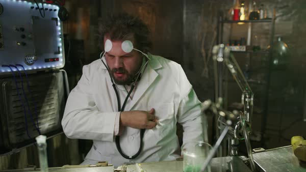 Mad scientist listening to electrodes attached to forehead with ...