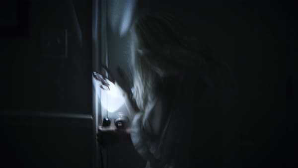 Woman hiding behind door from intruder - 4K Rights-managed Stock Video ...