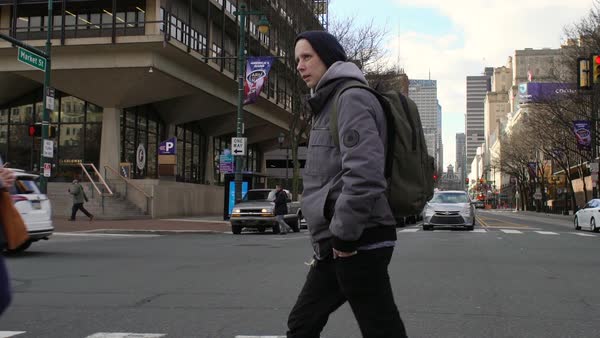 Tracking shot of a transgender man walking on a street in city - HD ...