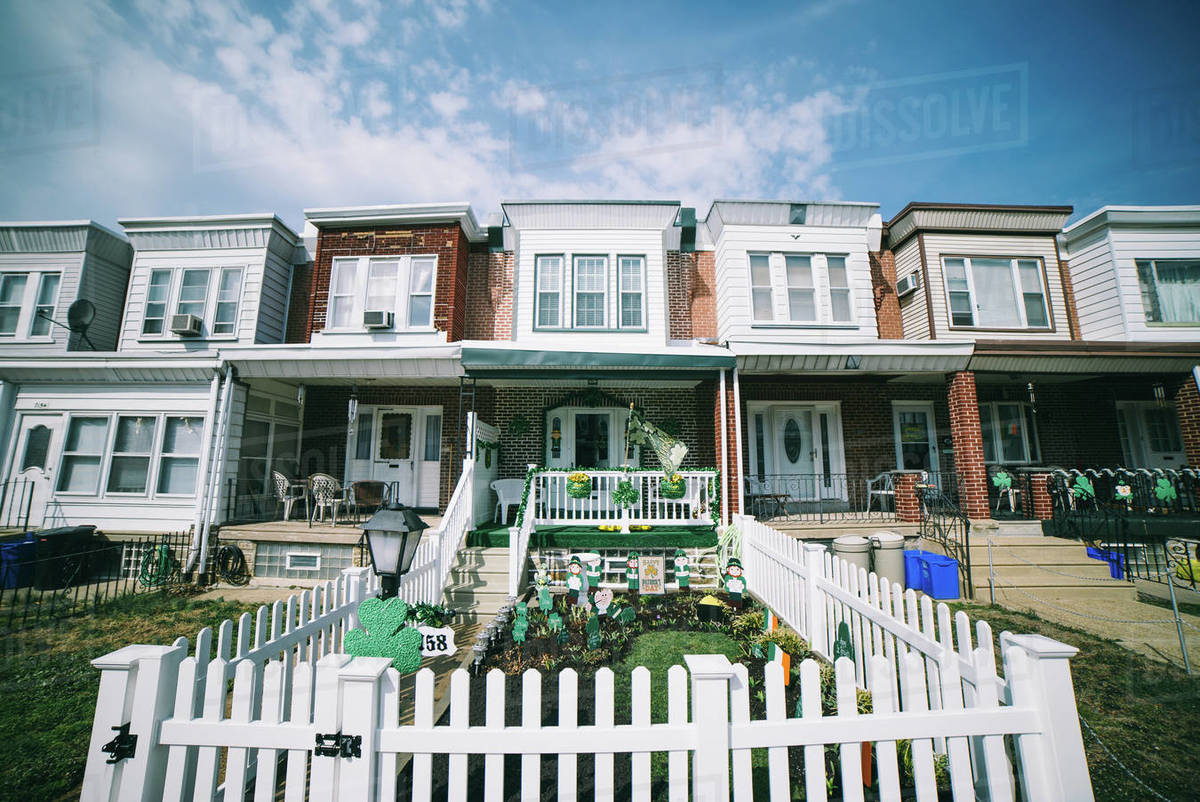 Exterior view of residential houses with garden decorations in ...