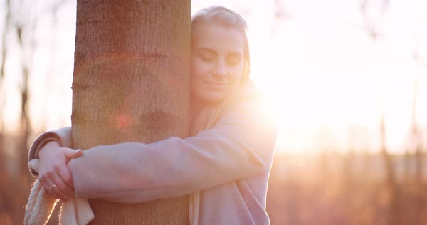 Beautiful loving nature woman hugs tree in forest in autumn - Stock ...
