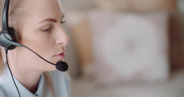 Sales representative in headset speaking to client and making video ...