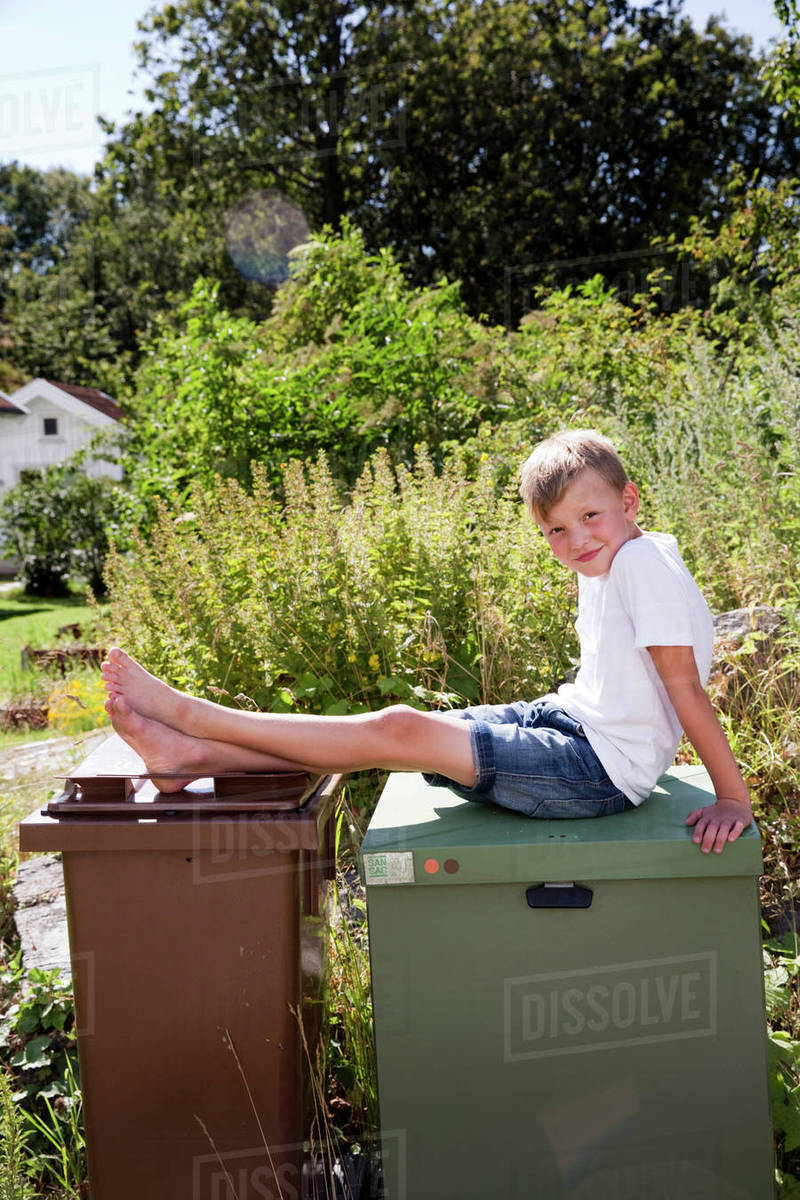 Boy sitting outside - Royalty-free Stock Photo | Dissolve