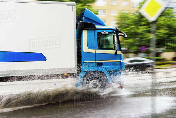 Lorry splashing water on road - Royalty-free Stock Photo | Dissolve