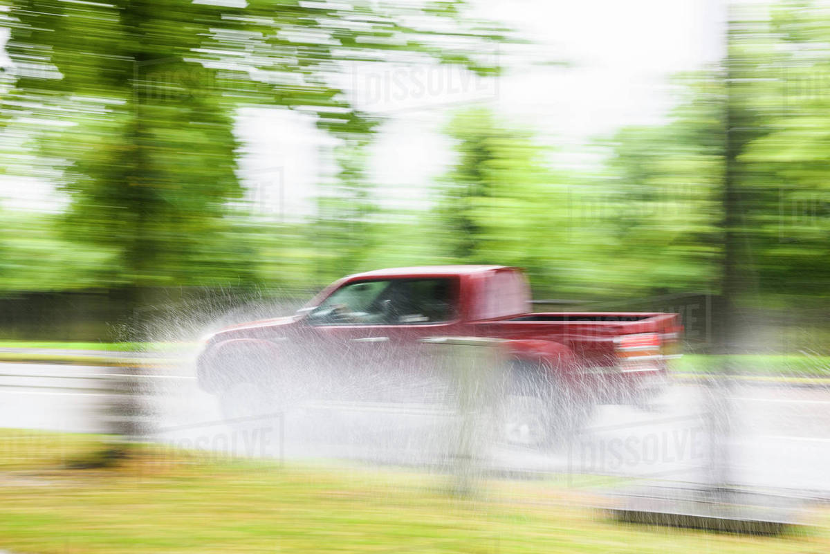 Car splashing water on road - Royalty-free Stock Photo | Dissolve