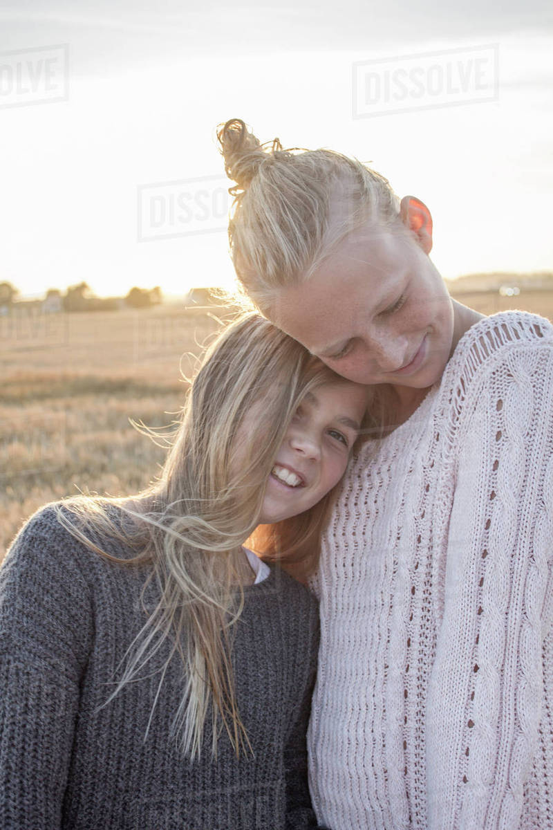 Two sisters at sunset - Royalty-free Stock Photo | Dissolve