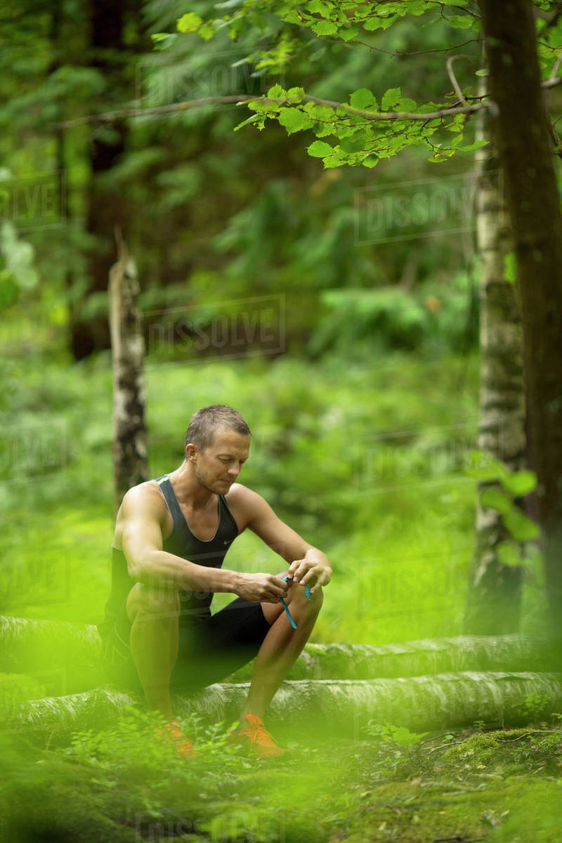 Man sitting in forest - Royalty-free Stock Photo | Dissolve