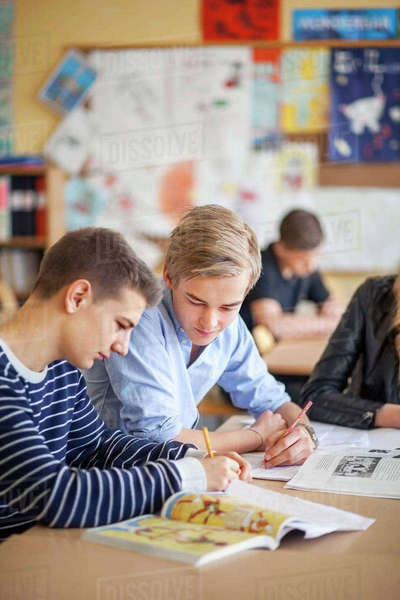 Teenage boys in classroom - Stock Photo - Dissolve