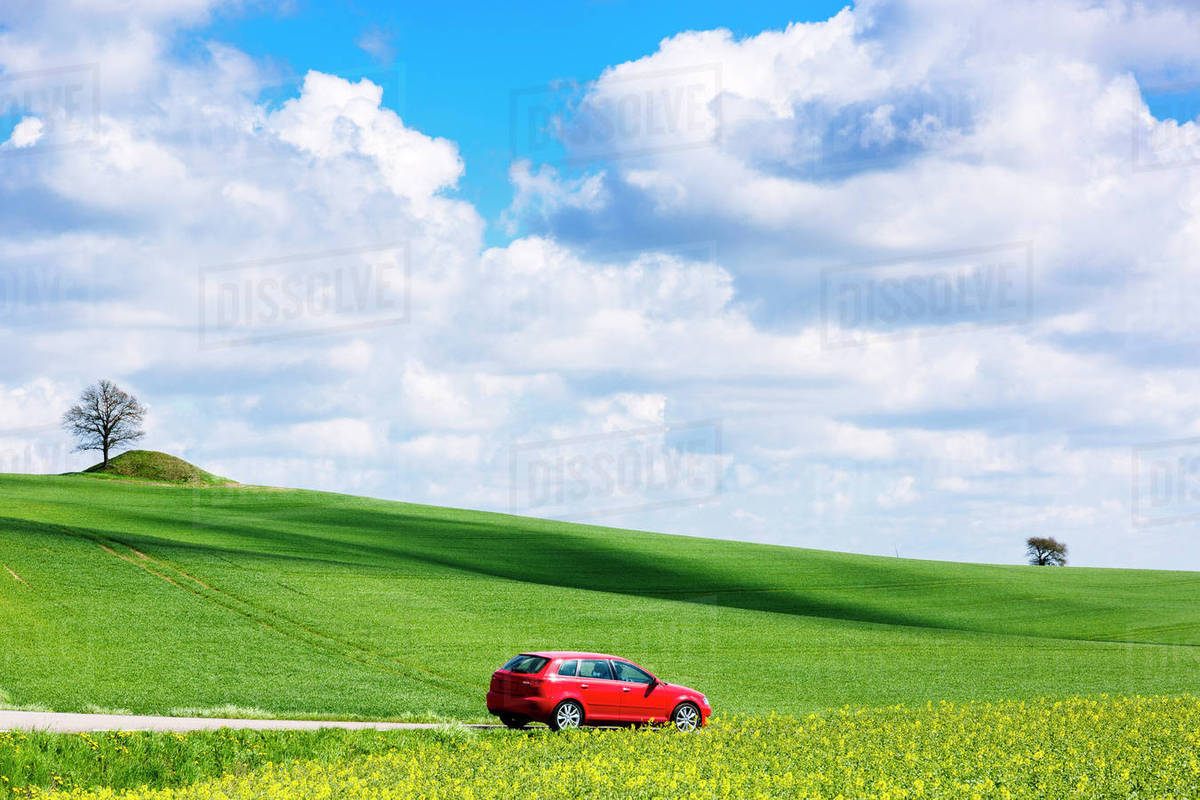Red car on country road - Royalty-free Stock Photo | Dissolve