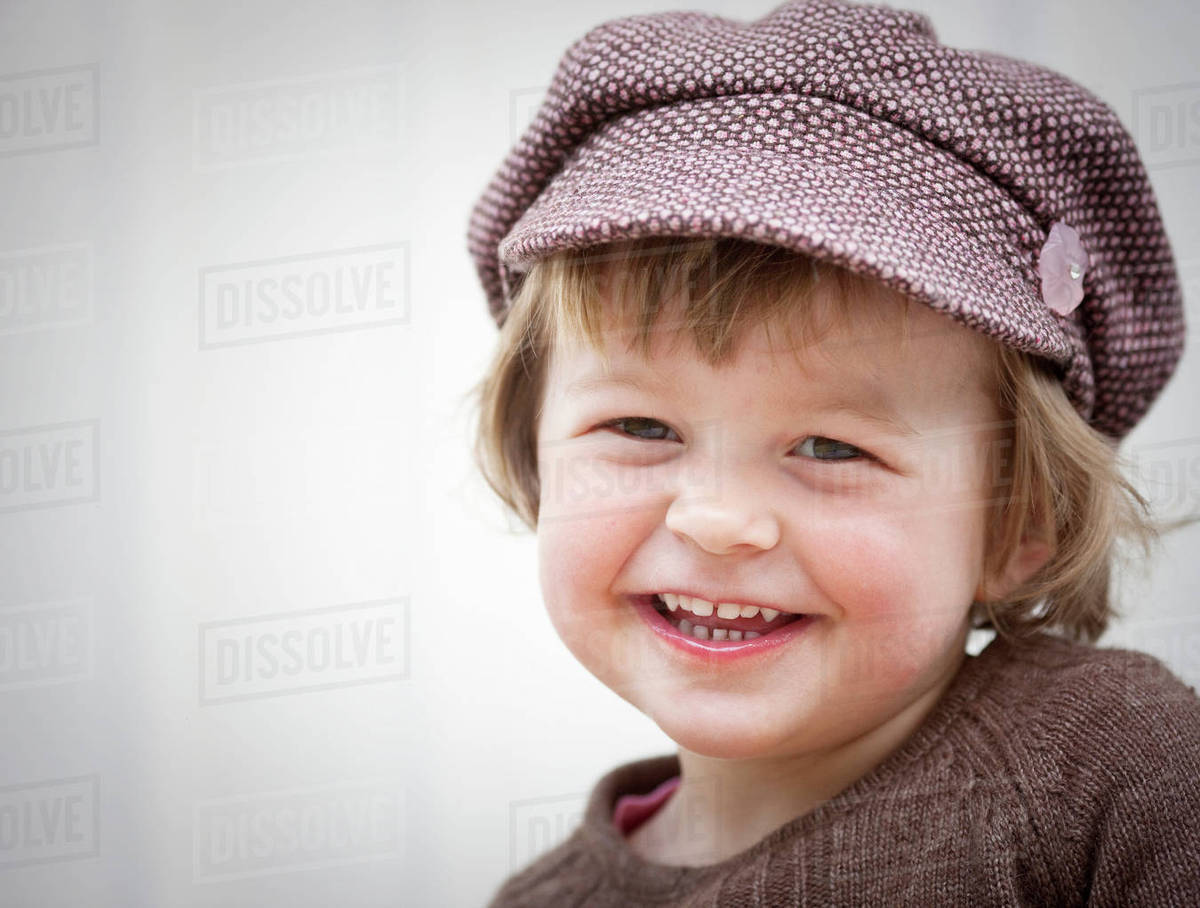 Smiling girl wearing cap - Royalty-free Stock Photo | Dissolve