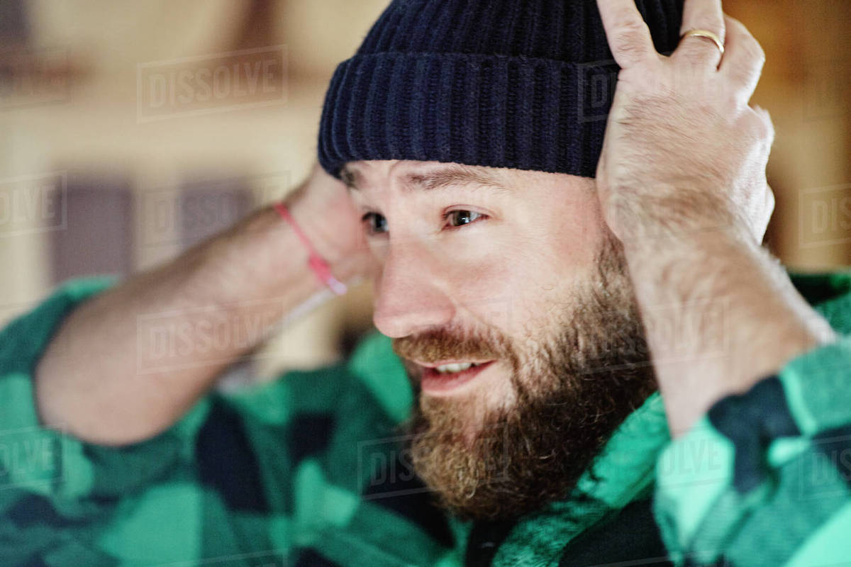 Man putting hat on - Royalty-free Stock Photo | Dissolve
