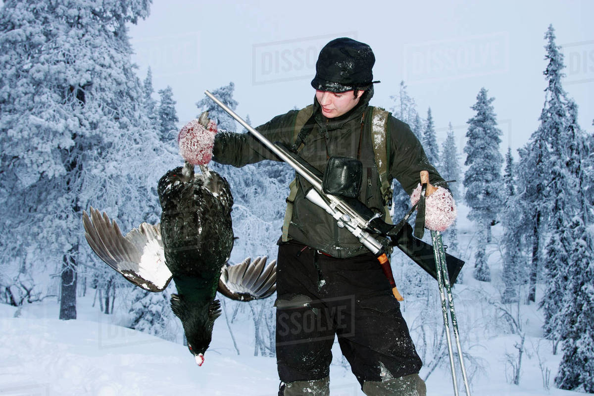 Hunter holding dead bird - Royalty-free Stock Photo | Dissolve