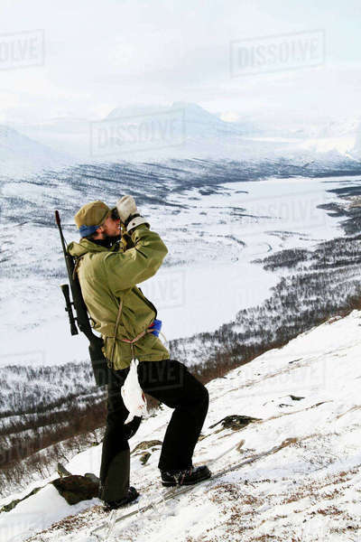 Hunter looking through binoculars - Royalty-free Stock Photo | Dissolve