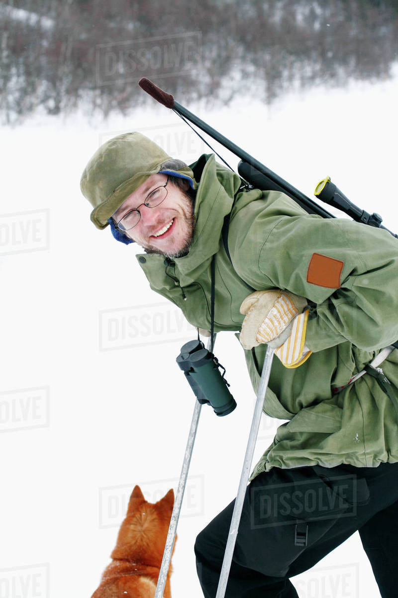 Smiling hunter skiing - Royalty-free Stock Photo | Dissolve